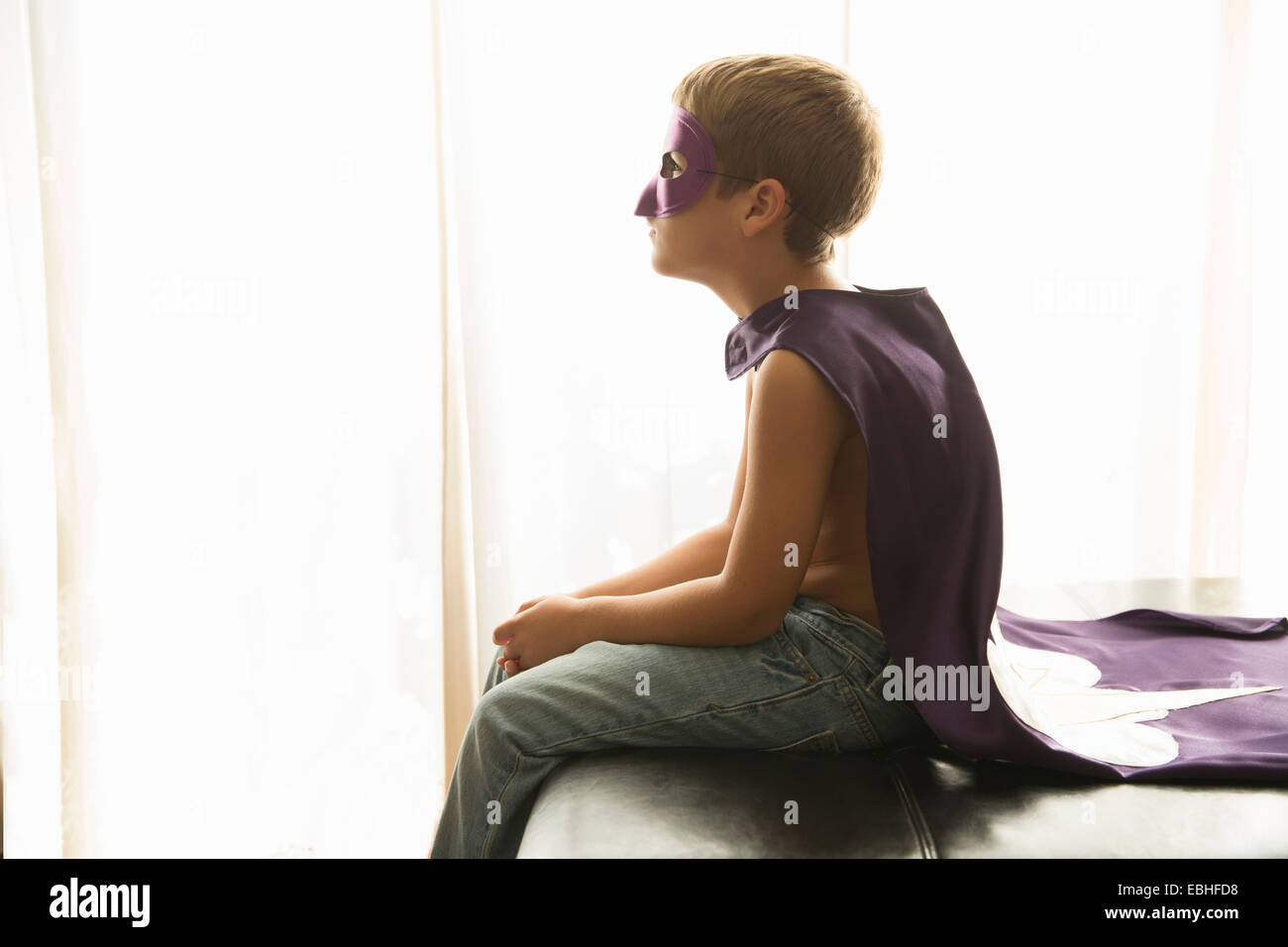 Boy in cape and mask at home Stock Photo - Alamy