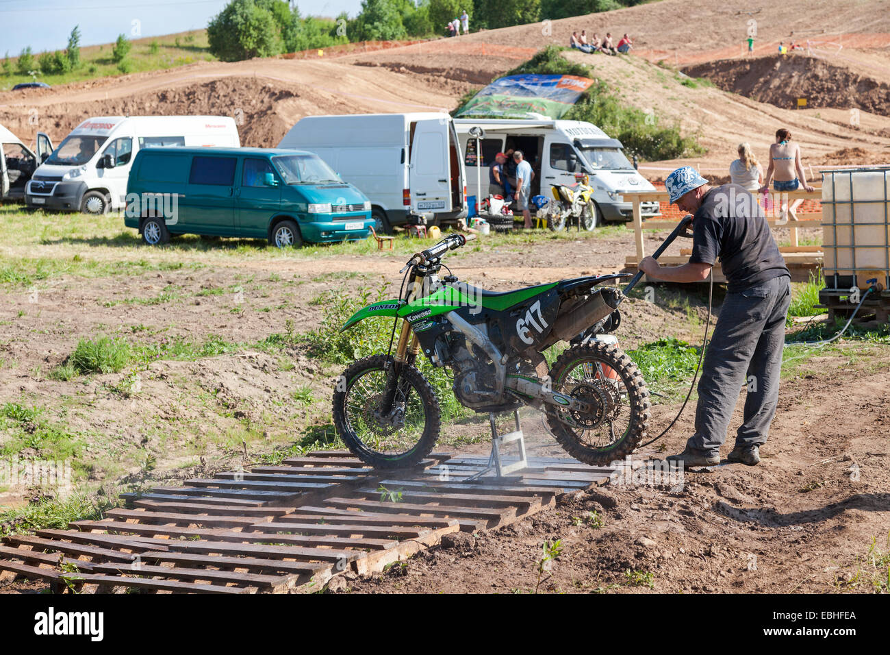 Man washing a race bike after the competition in motocross Stock Photo ...