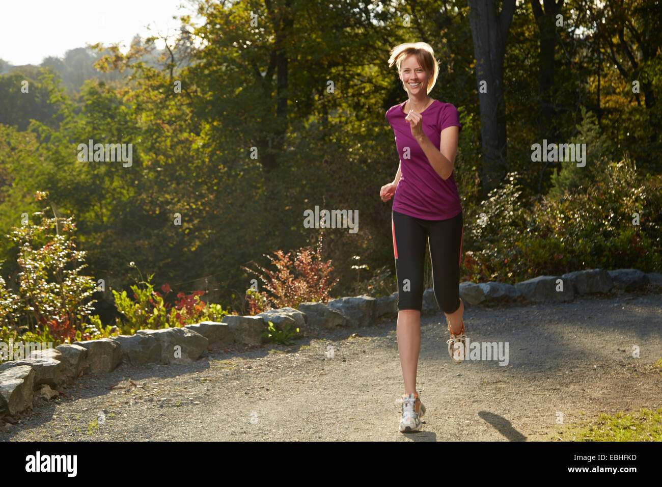 Woman running in front hi-res stock photography and images - Alamy