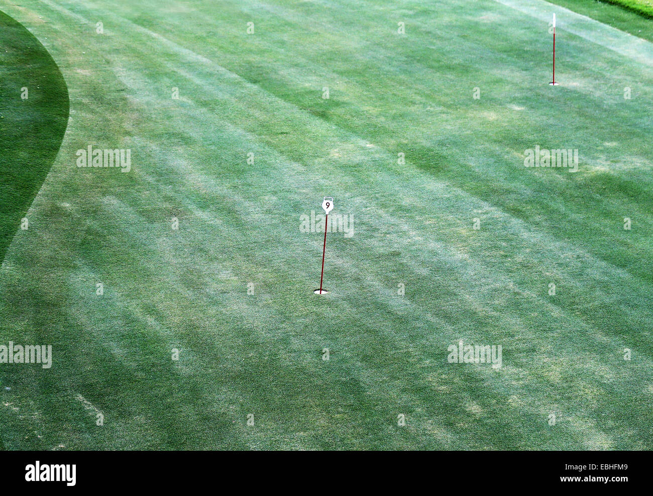 Golf course with green grass and blue well to the sword Stock Photo - Alamy