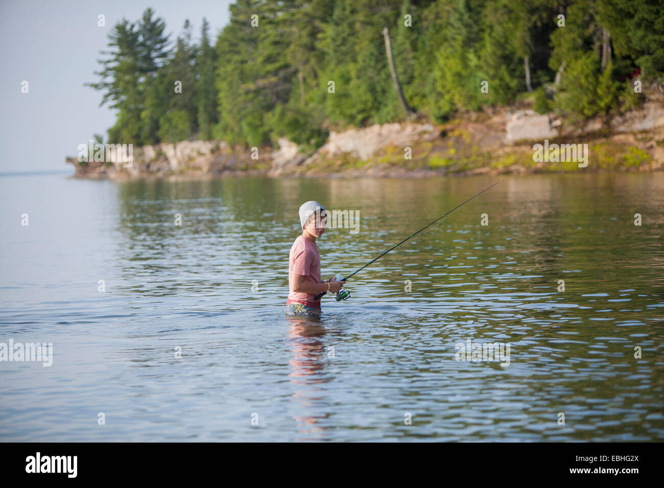 Wading teenage boy fishing in Lake Superior, Au Train Bay, Michigan ...