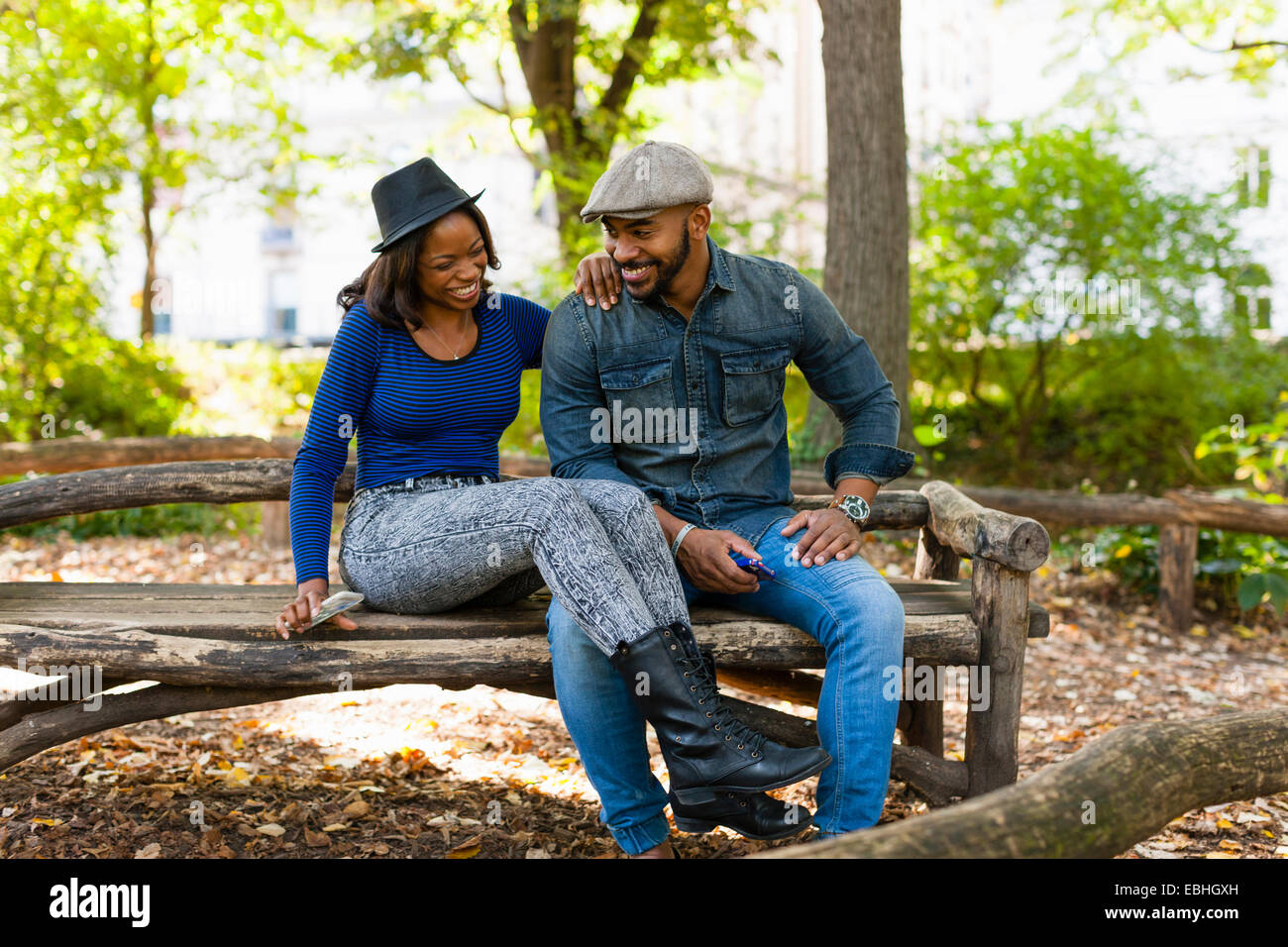 Couple chatting on bench Stock Photo - Alamy