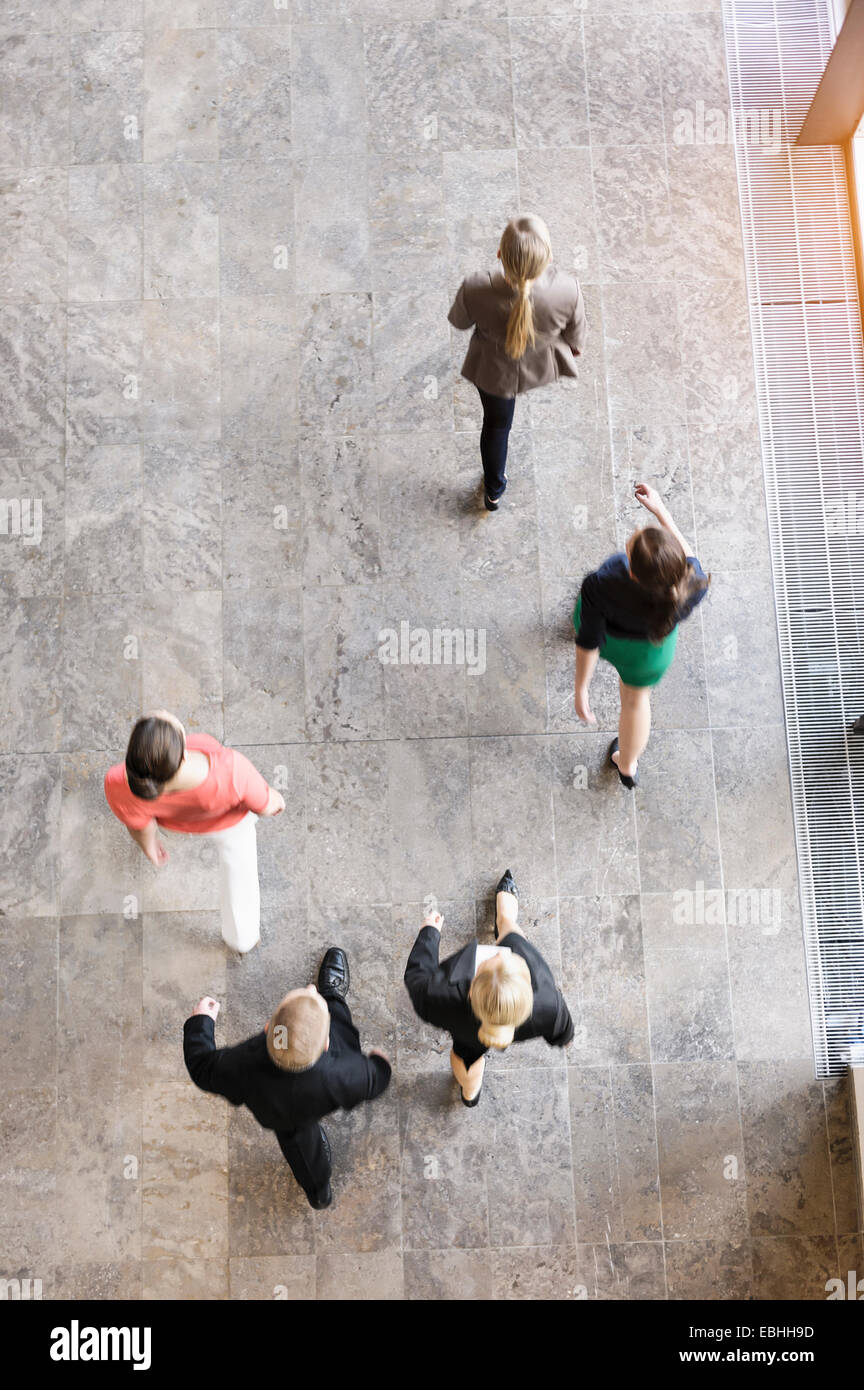 Overhead view of businesswomen and man walking in same direction Stock ...