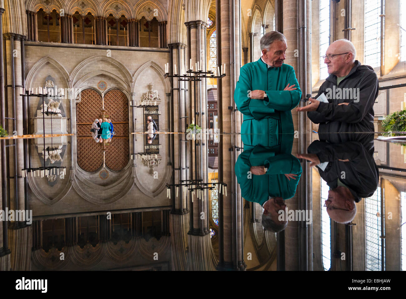 Church official & visitor discussion talking,& reflection / reflecting ...