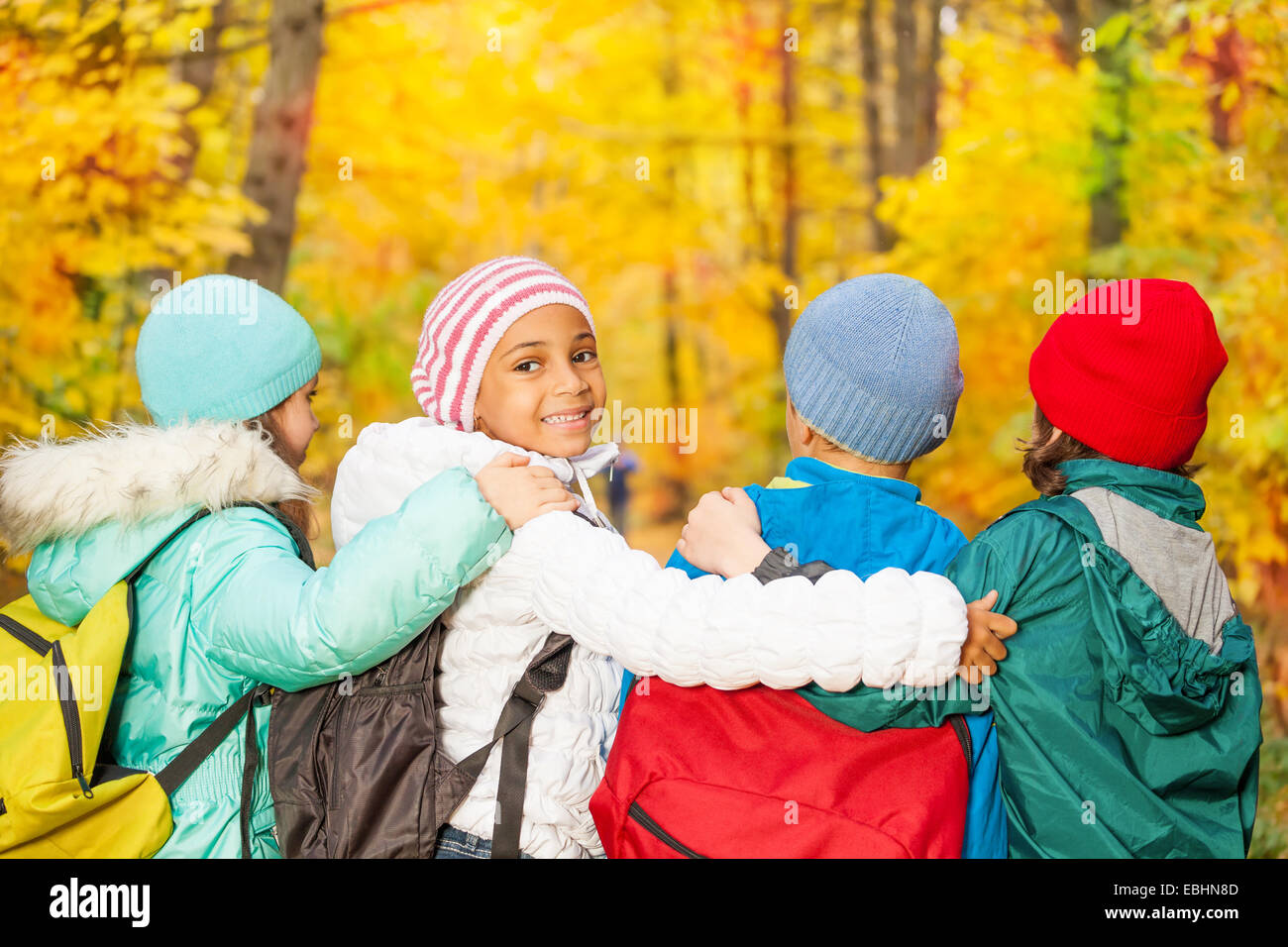 Back of kids with rucksacks standing in row close Stock Photo - Alamy