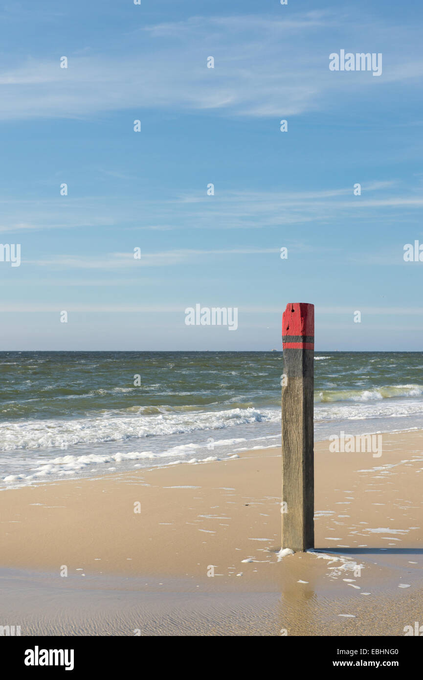Wooden red beach pole at the coast of the Northsea Stock Photo - Alamy