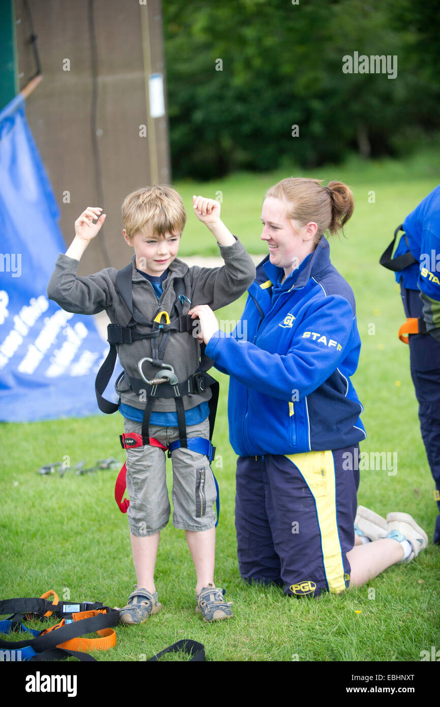 Kids learning to climb on an adventure school Stock Photo - Alamy