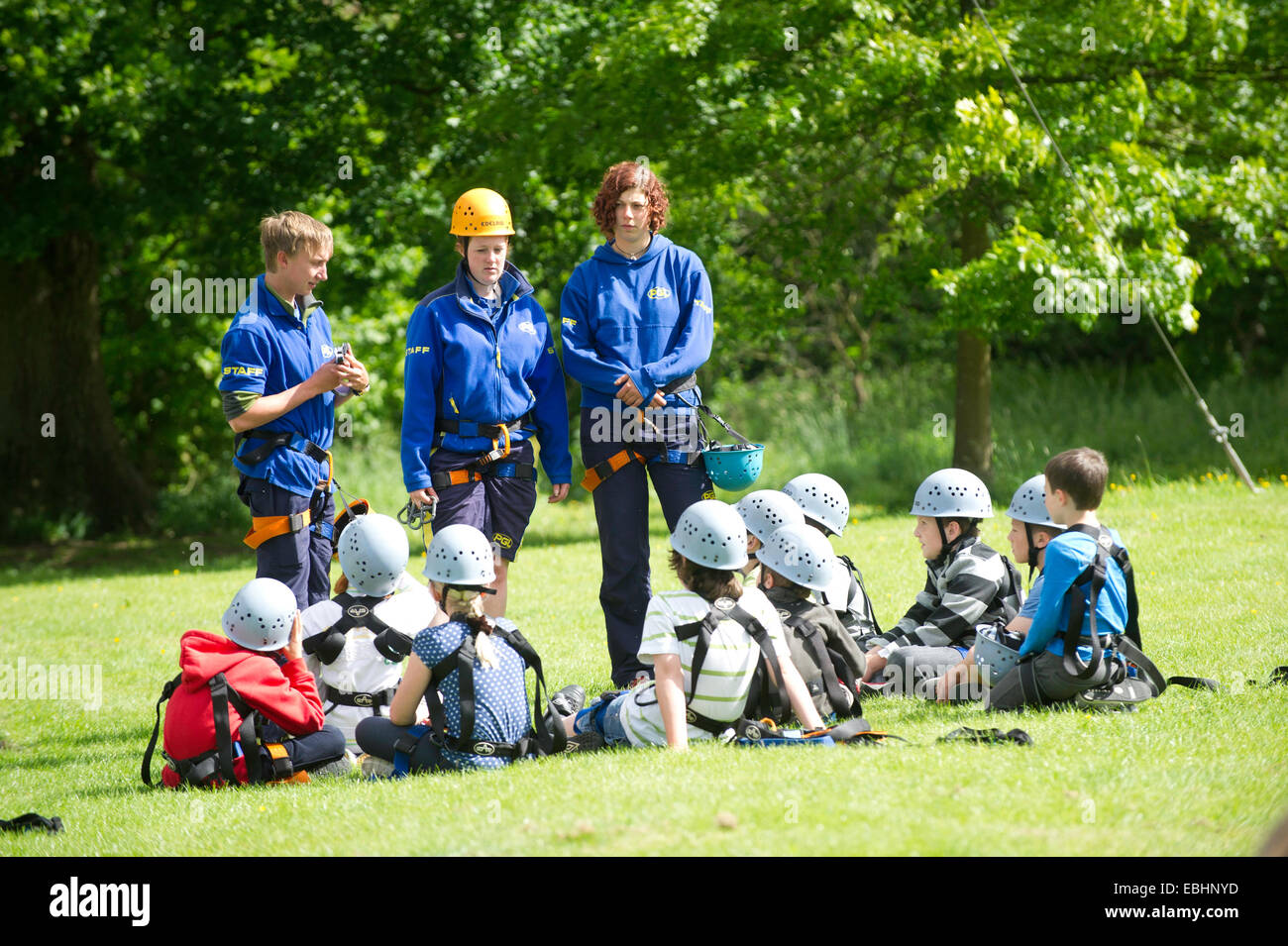 Kids learning to climb on an adventure school Stock Photo - Alamy