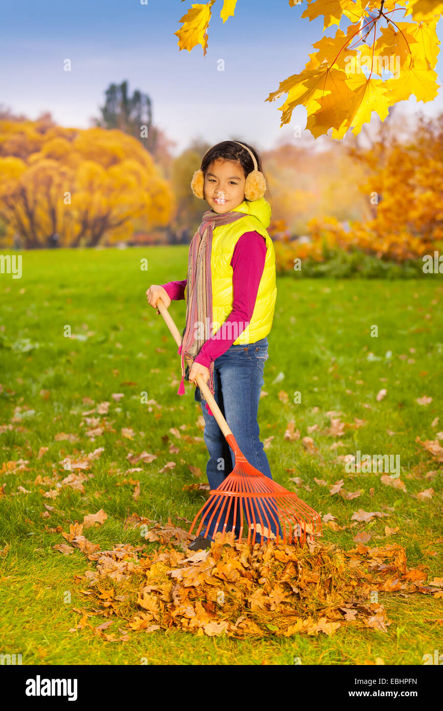 Beautiful Asian girl with big red rake working Stock Photo - Alamy