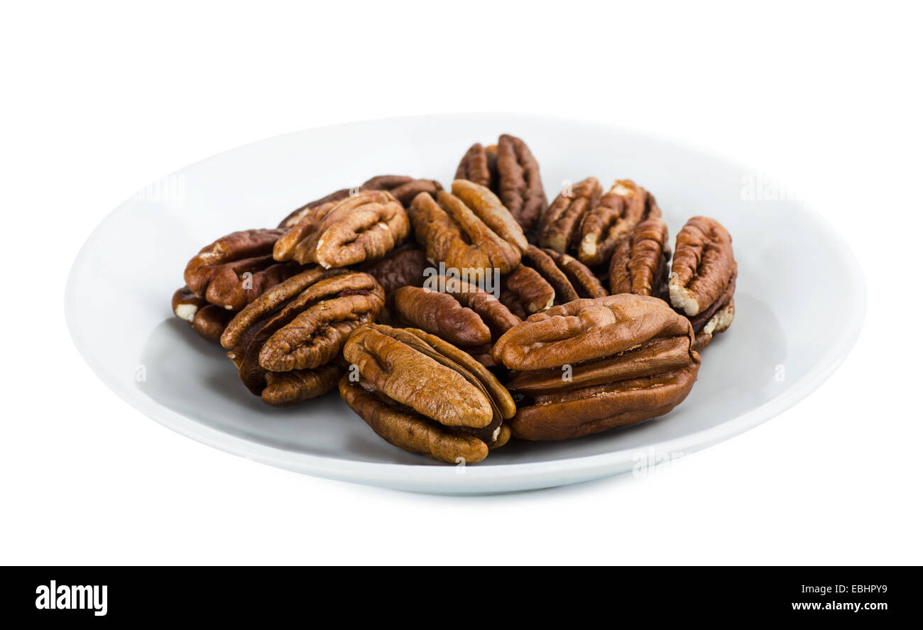 Pecans on a plate on a white background Stock Photo - Alamy