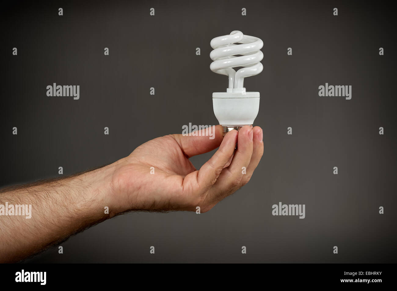 Energy-saving bulb CFL in man’s hand Stock Photo - Alamy