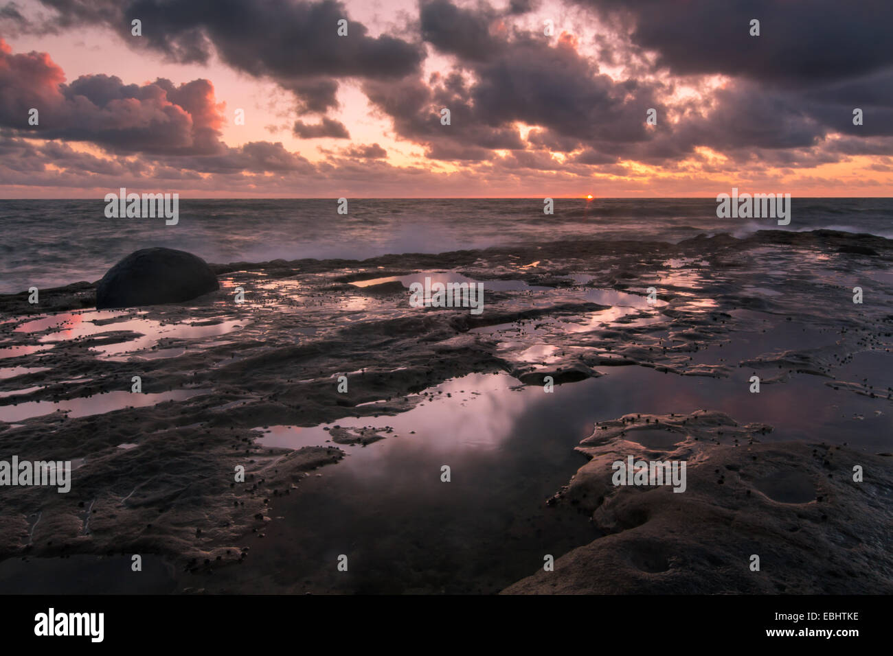 Pacific Ocean sunset reflected in tide pools near San Diego's Sunset ...
