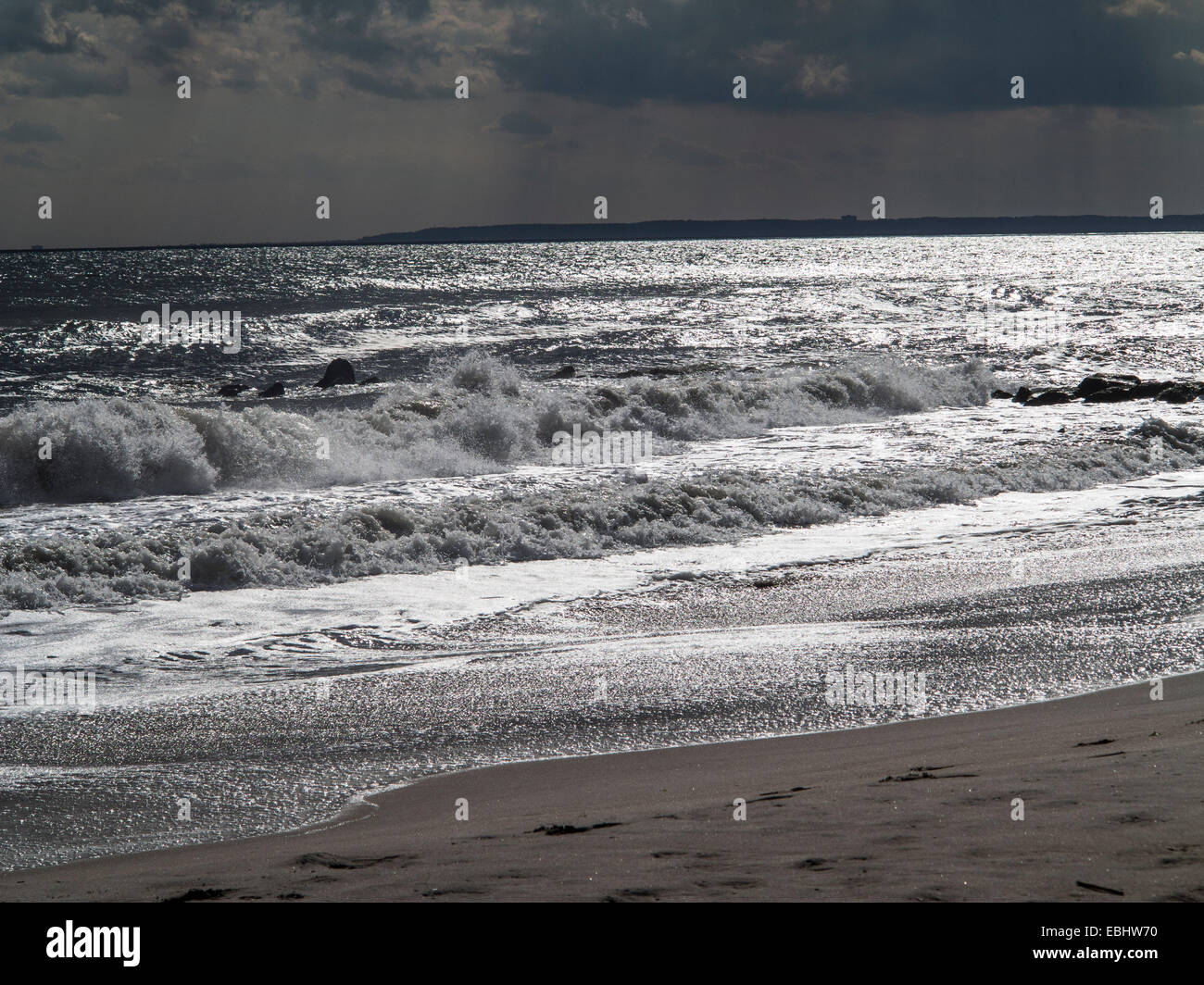Atlantic sea shore line,light blue sky sun breaking threw clouds making ...