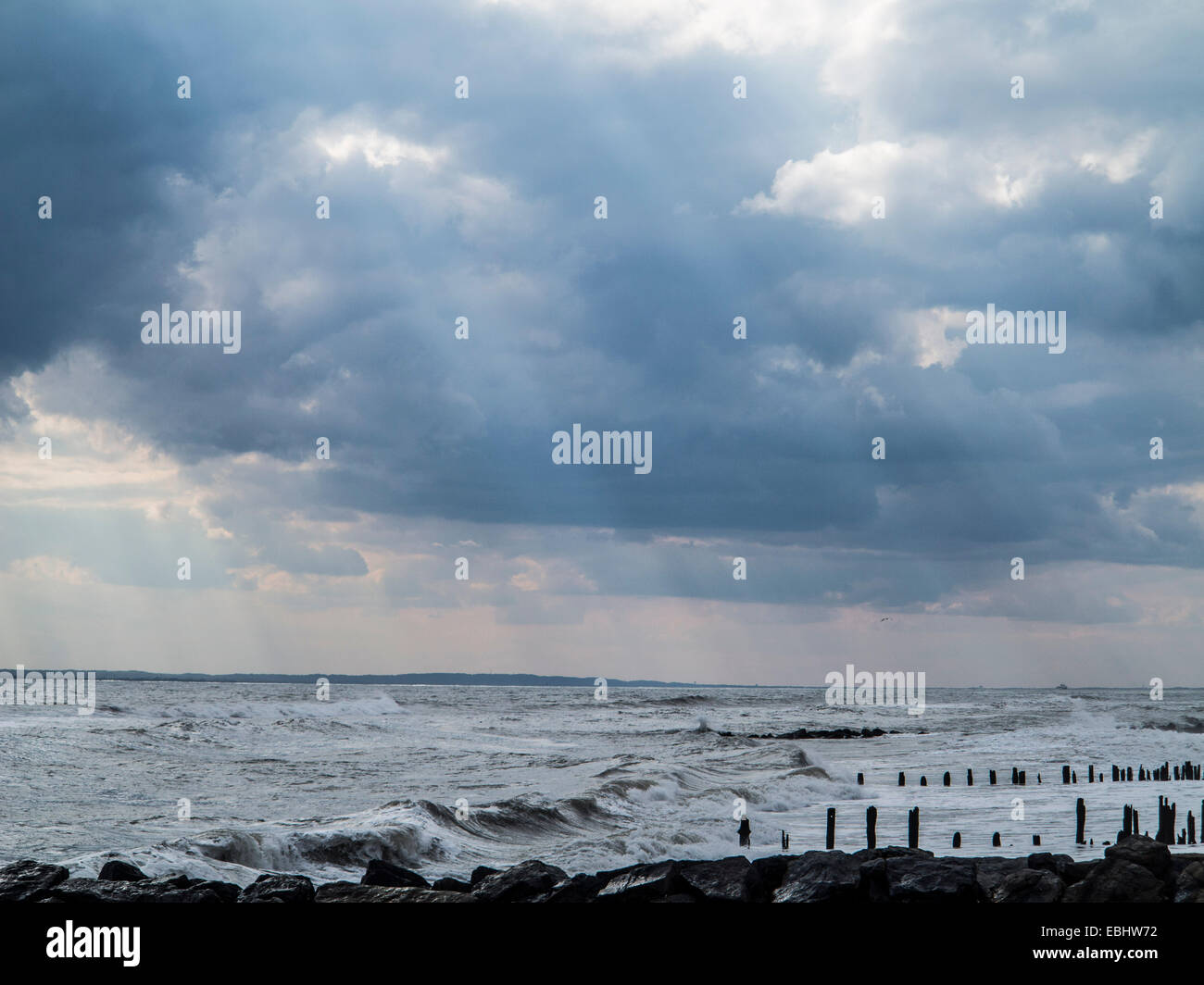 Atlantic ocean shore line with wooden docks light blue sky sun breaking ...