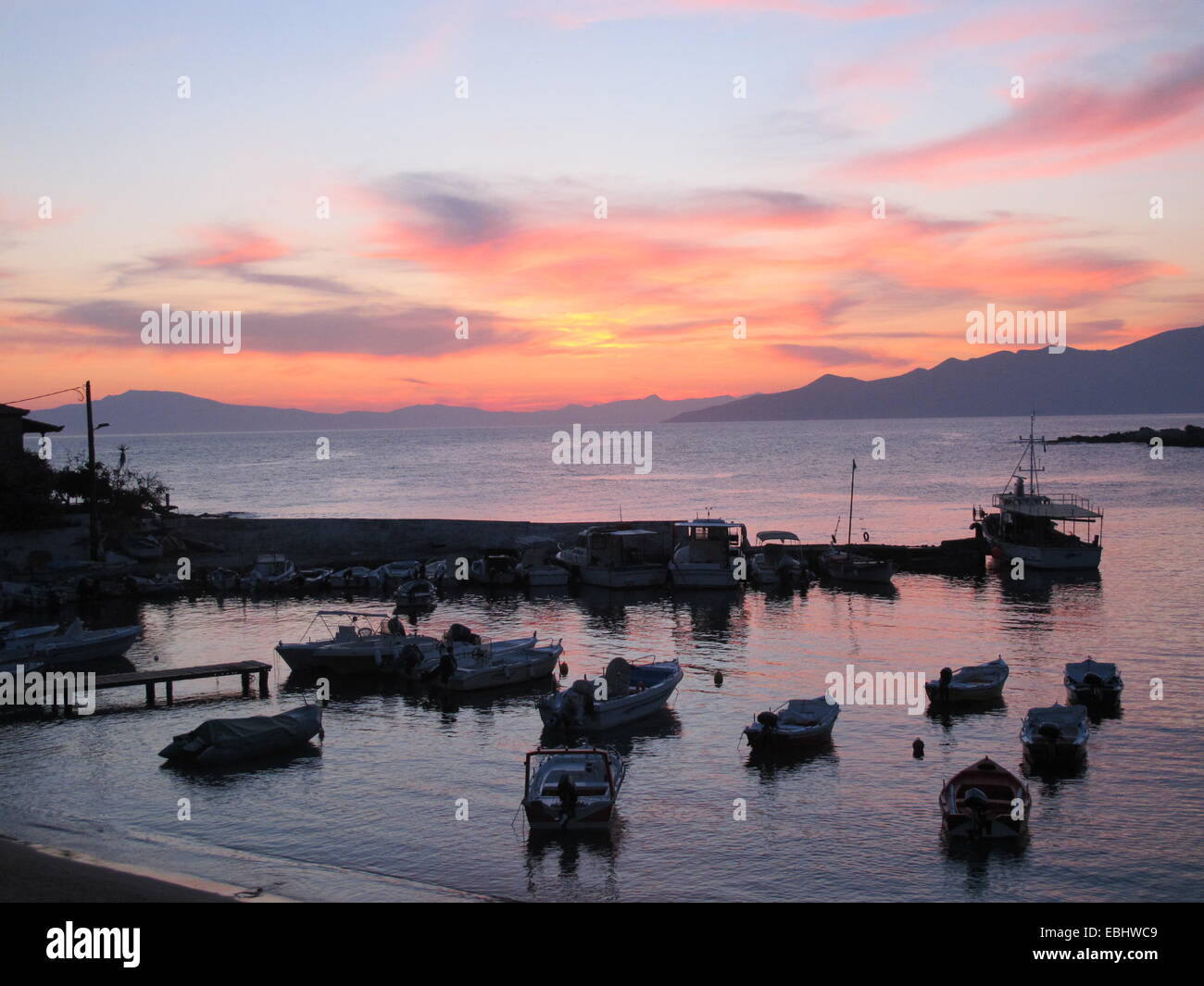Greek harbour at sunset Stock Photo - Alamy