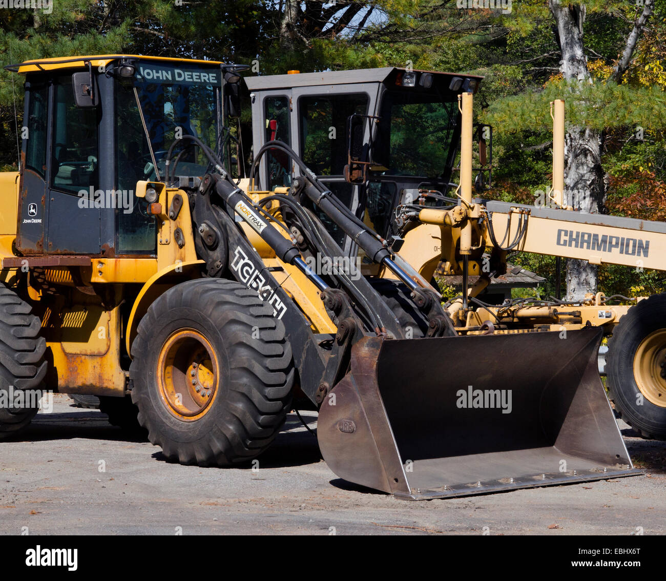 John Deere TC54H Tractor earth mover next to a road grader Stock Photo ...