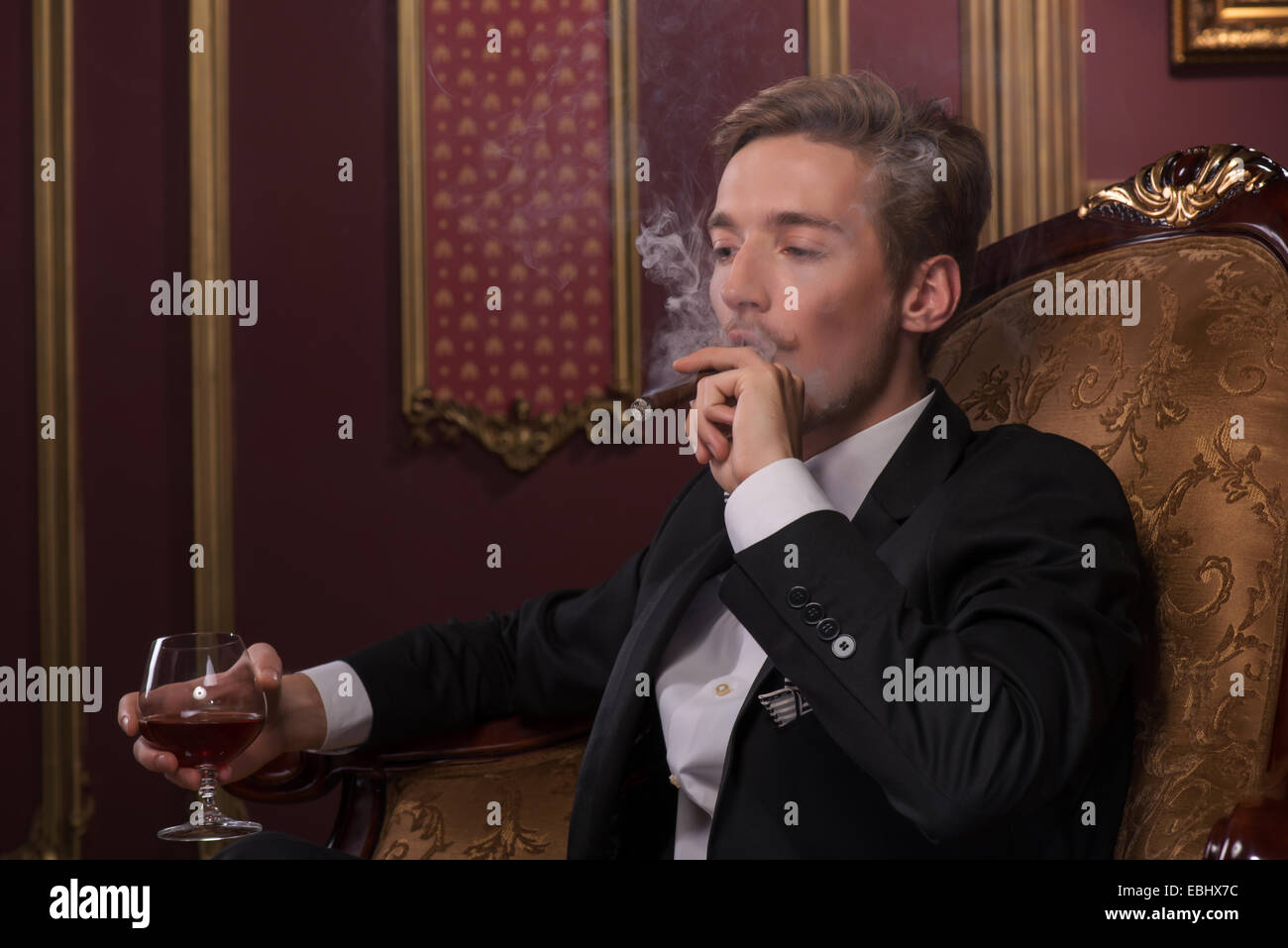 Handsome man with cigar Stock Photo - Alamy