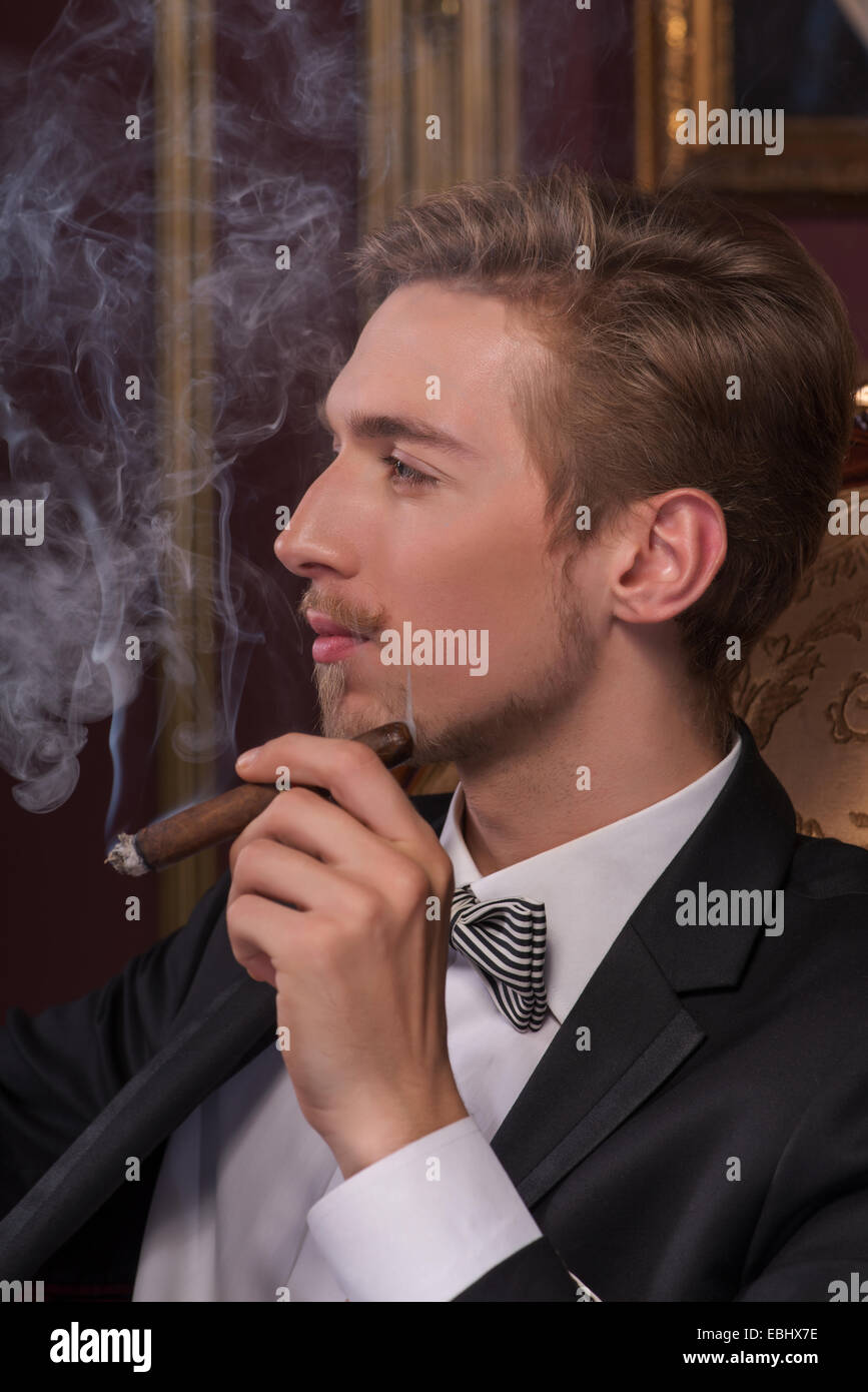 Businessman smoking cigar hi-res stock photography and images - Alamy