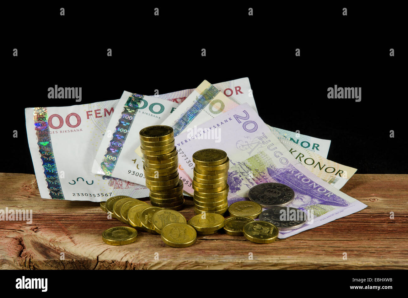 Bunch of swedish cash money on an old wooden table at black background ...