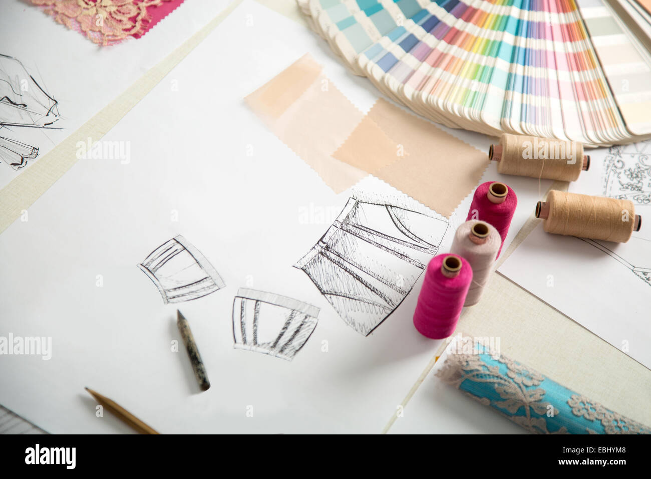 fashion designers, working in progress on tailor table Stock Photo - Alamy