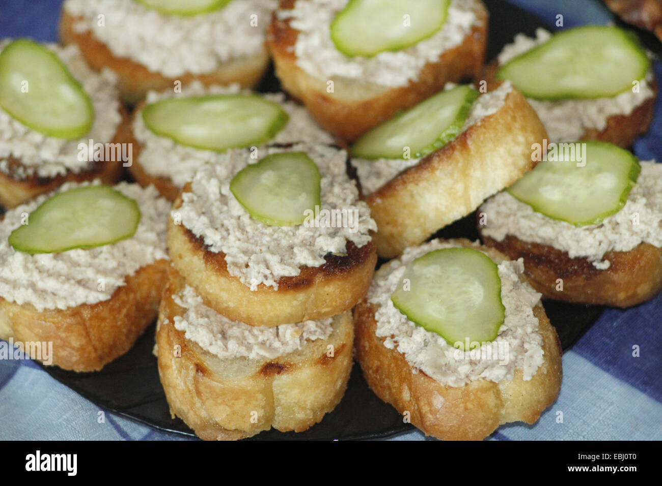 delicious toast with cod's liver and cucumbers Stock Photo - Alamy