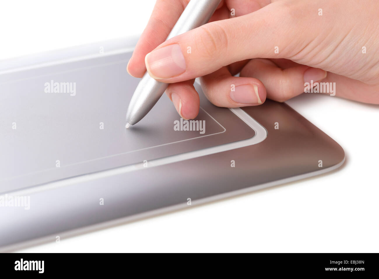 Female hand, holding stylus, making use of pen tablet, close-up shot ...