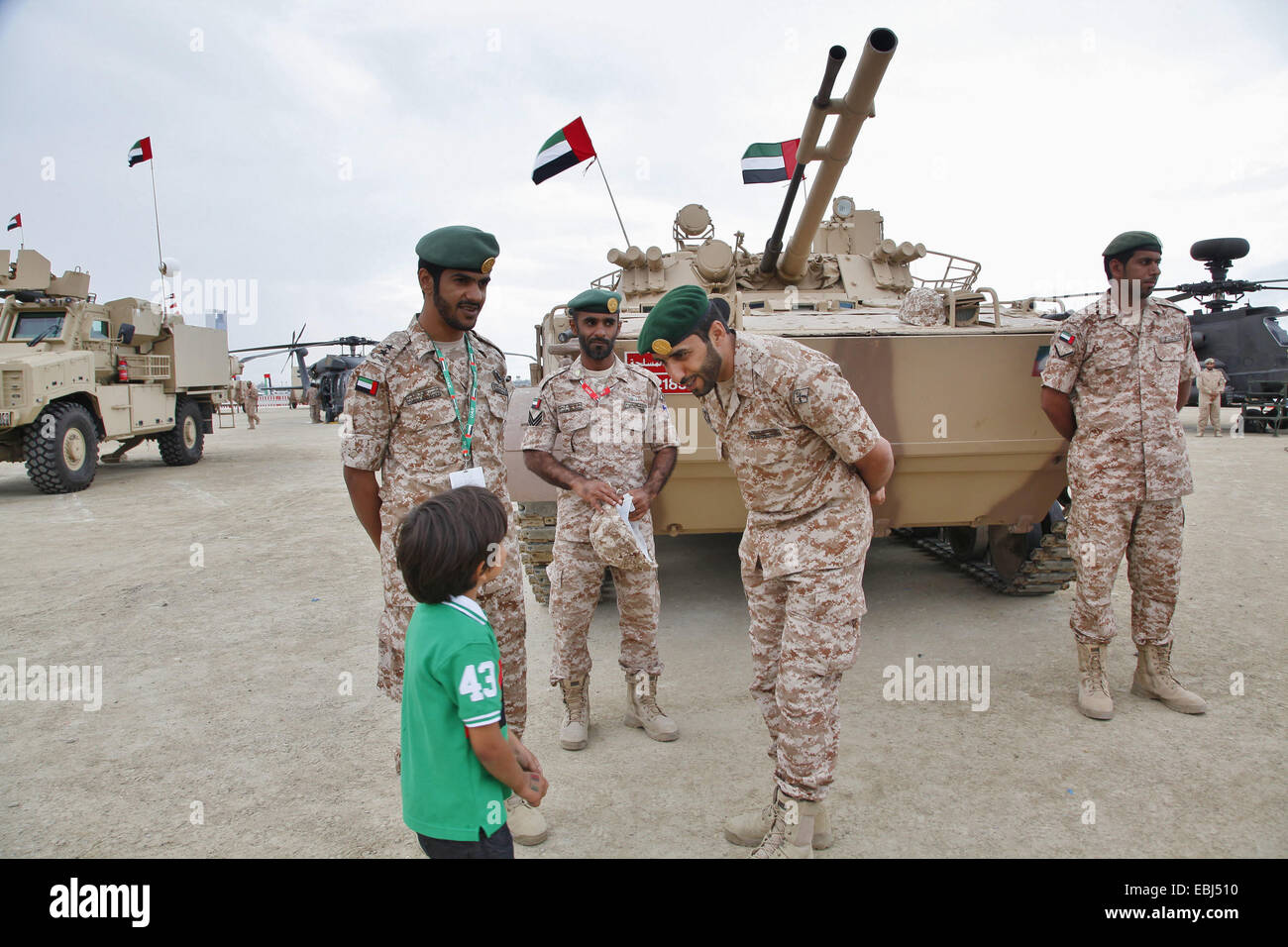 A service man talks with a child during a military show to celebrate ...