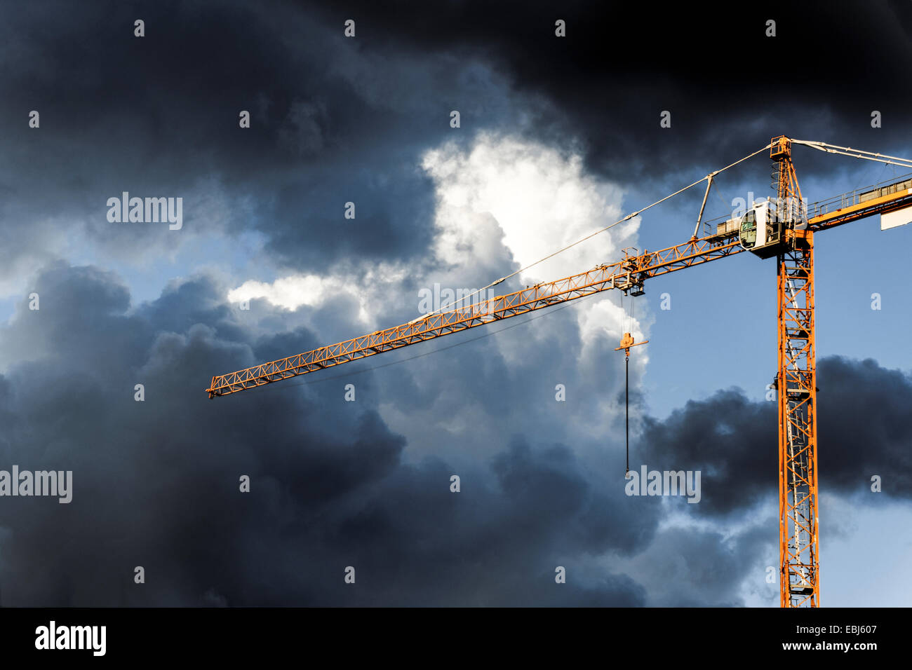 Construction site crane with storm clouds Stock Photo - Alamy