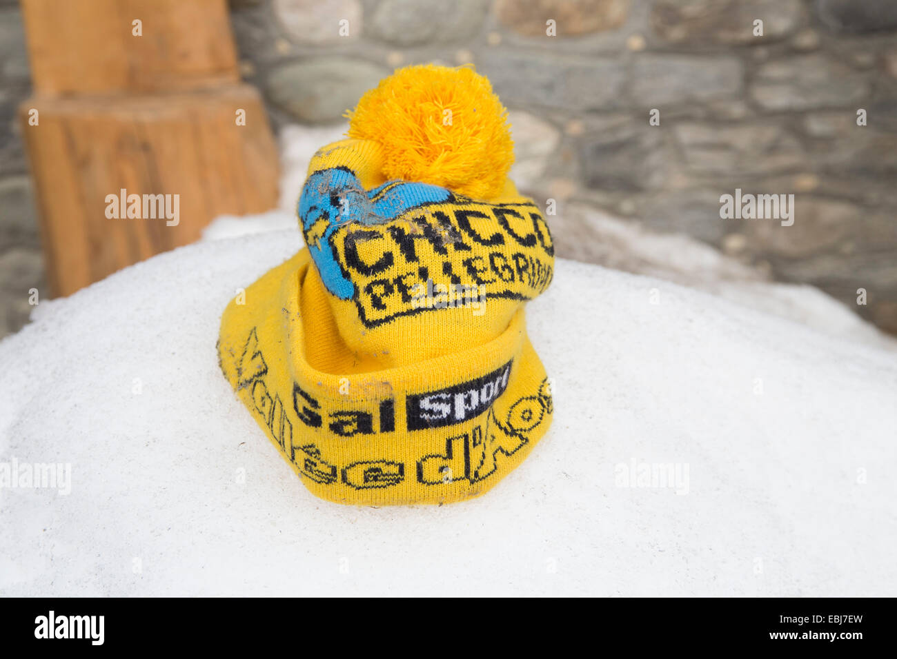 Yellow woolly bobble hat on snow Stock Photo - Alamy