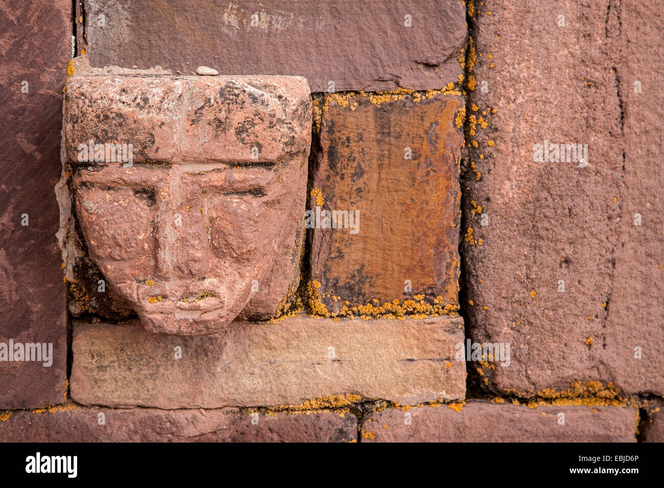 Carved stone tenon-heads embedded in wall of the semi-subterranean ...