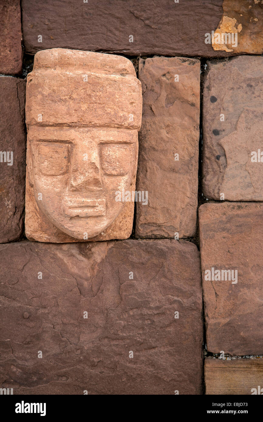 Carved stone tenon-heads embedded in wall of the semi-subterranean ...