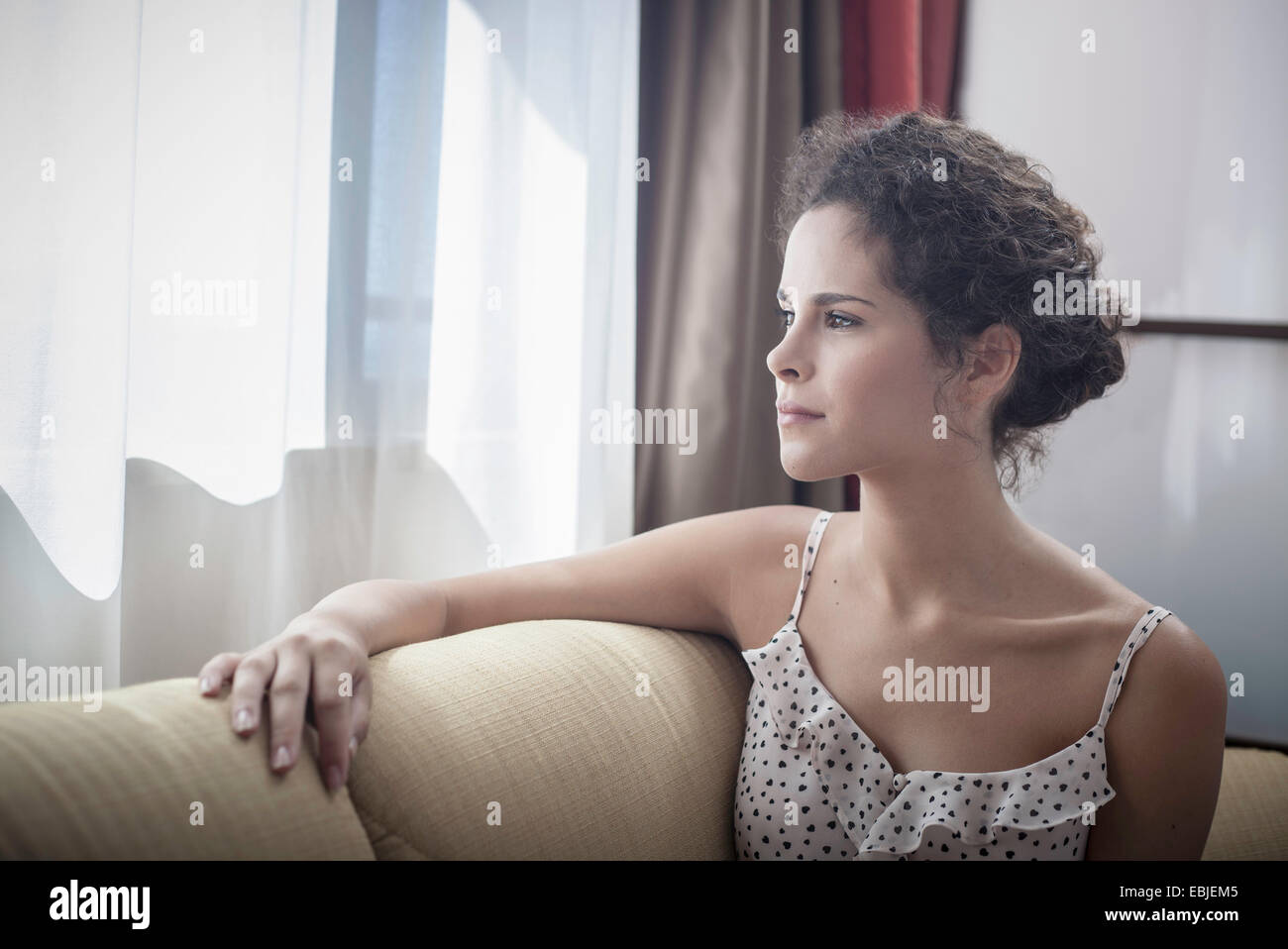 Woman looking out window at home hi-res stock photography and images ...