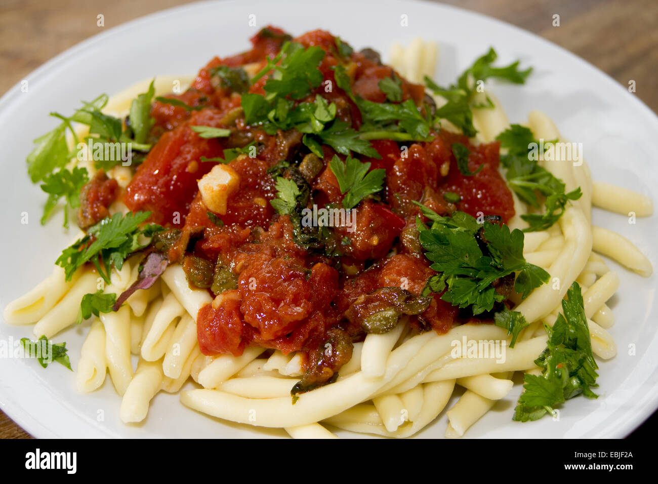 traditional and typical roman dish: pasta alla puttanesca Stock Photo ...