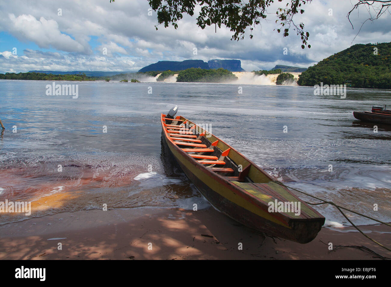 dugout in a lagoon, Canaima waterfalls in background, Venezuela ...
