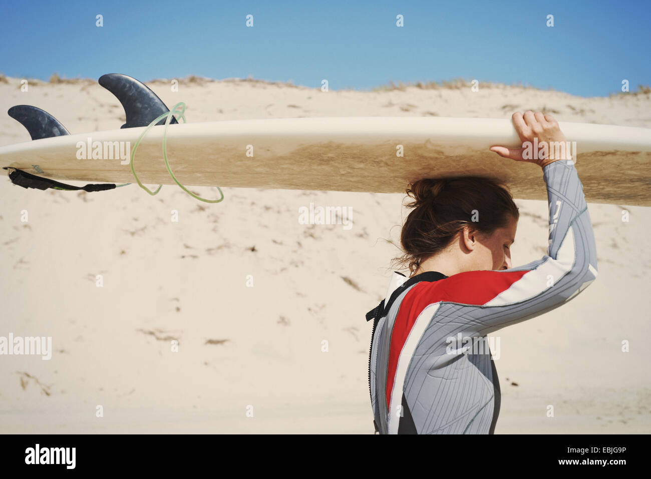 Surfer carrying surfboard on head at beach, Lacanau, France Stock Photo ...