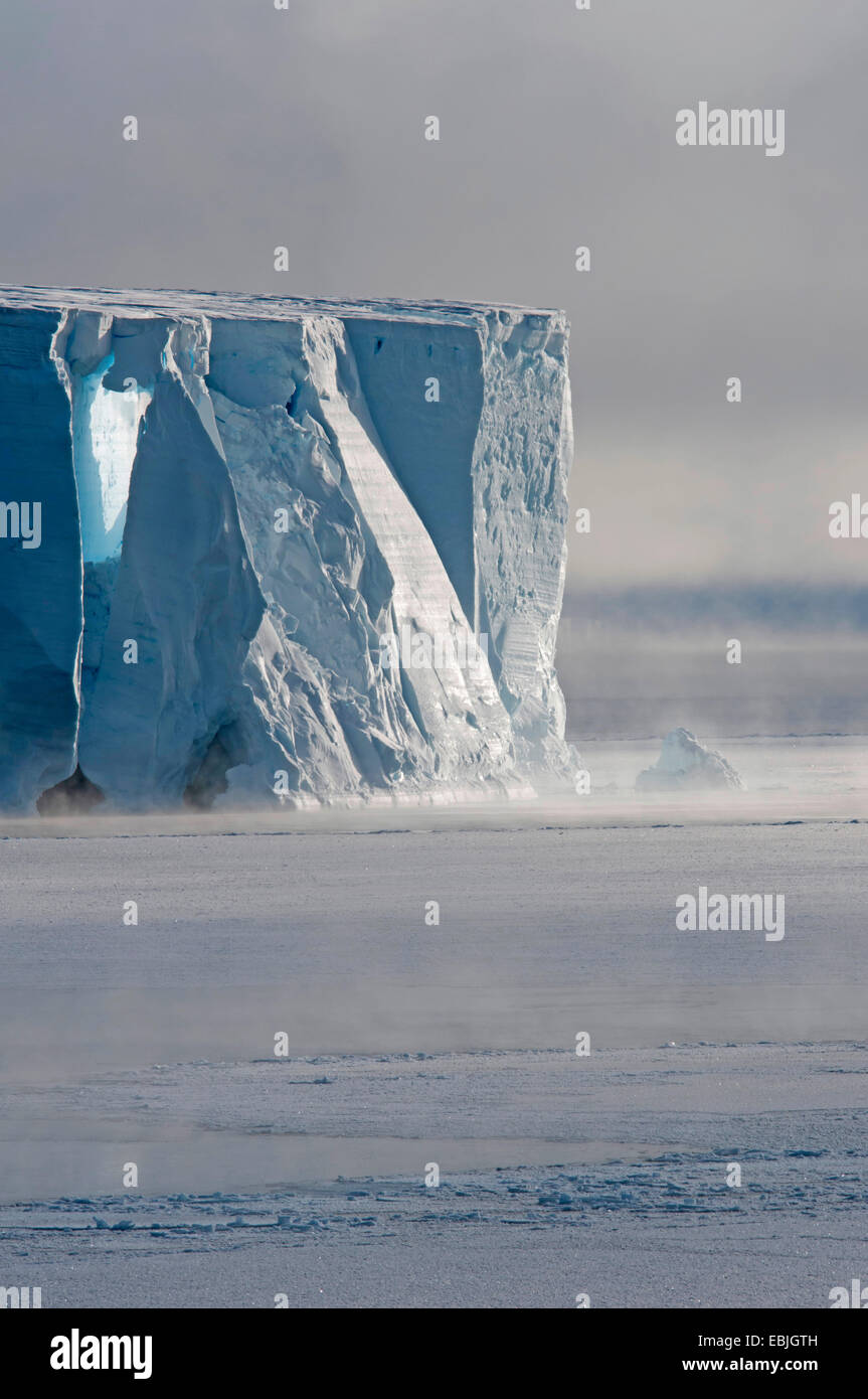 mist around the edge of a table iceberg near the iceberg resting place ...