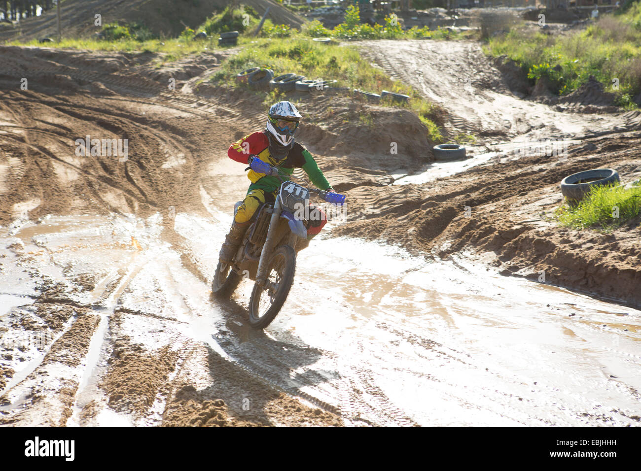 Young male motocross rider racing on muddy track Stock Photo - Alamy