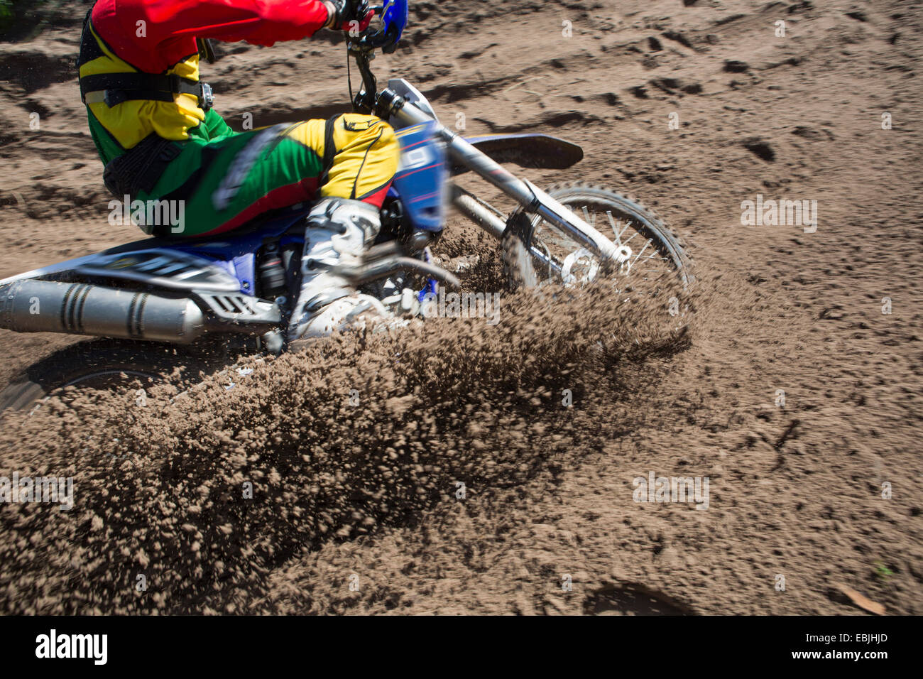 Young male motocross rider racing through mud track Stock Photo - Alamy
