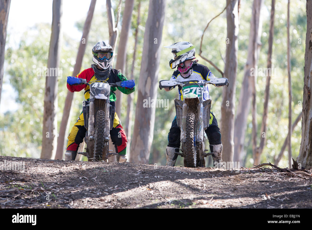 Two young male motocross riders chatting in forest Stock Photo - Alamy