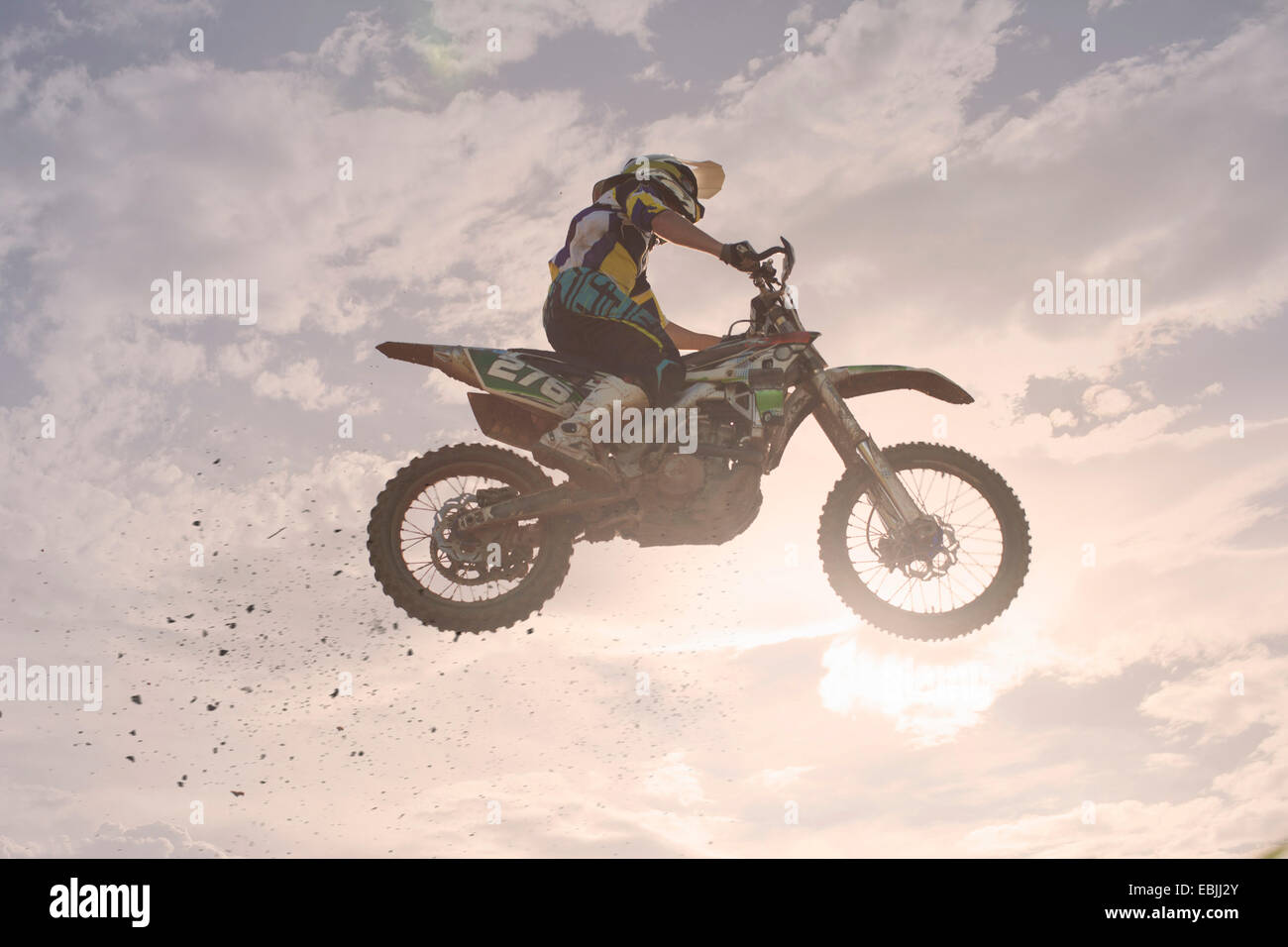 Silhouetted young male motocross racer jumping mid air Stock Photo - Alamy