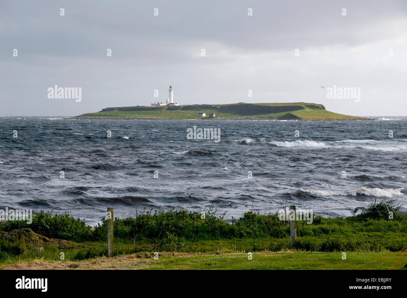 view from Arran Island to Pladda island with lighthouse, United Kingdom ...