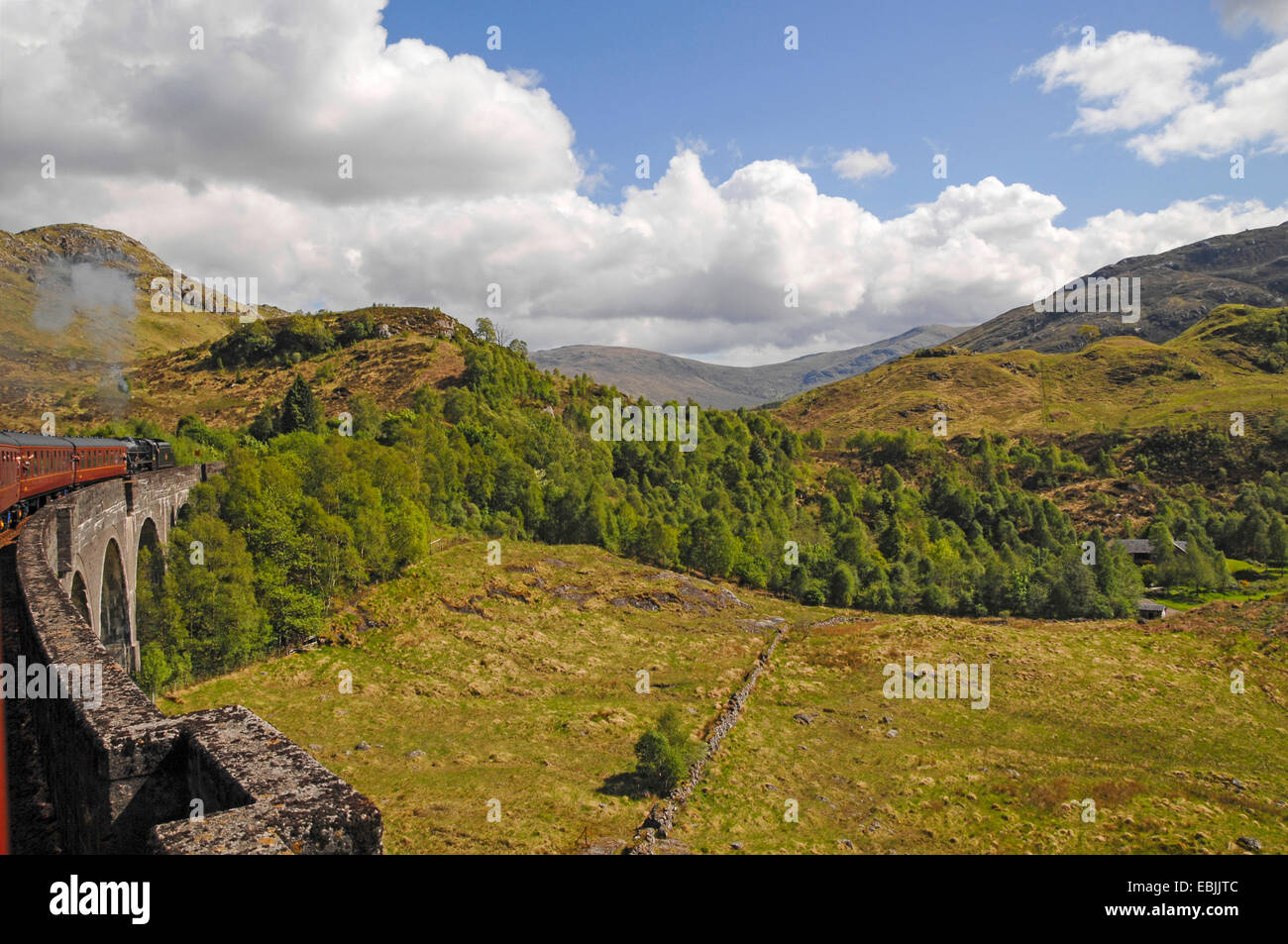 view out of a steam train of the West Highland Line at the hill ...
