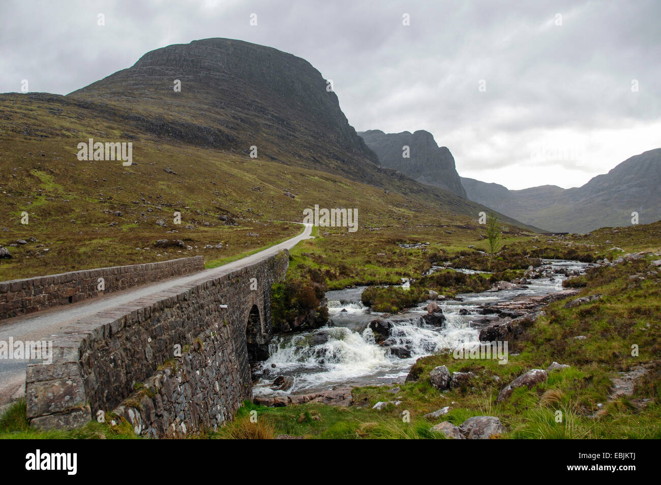 Road over a stone bridge through Scottish highlands, United Kingdom ...