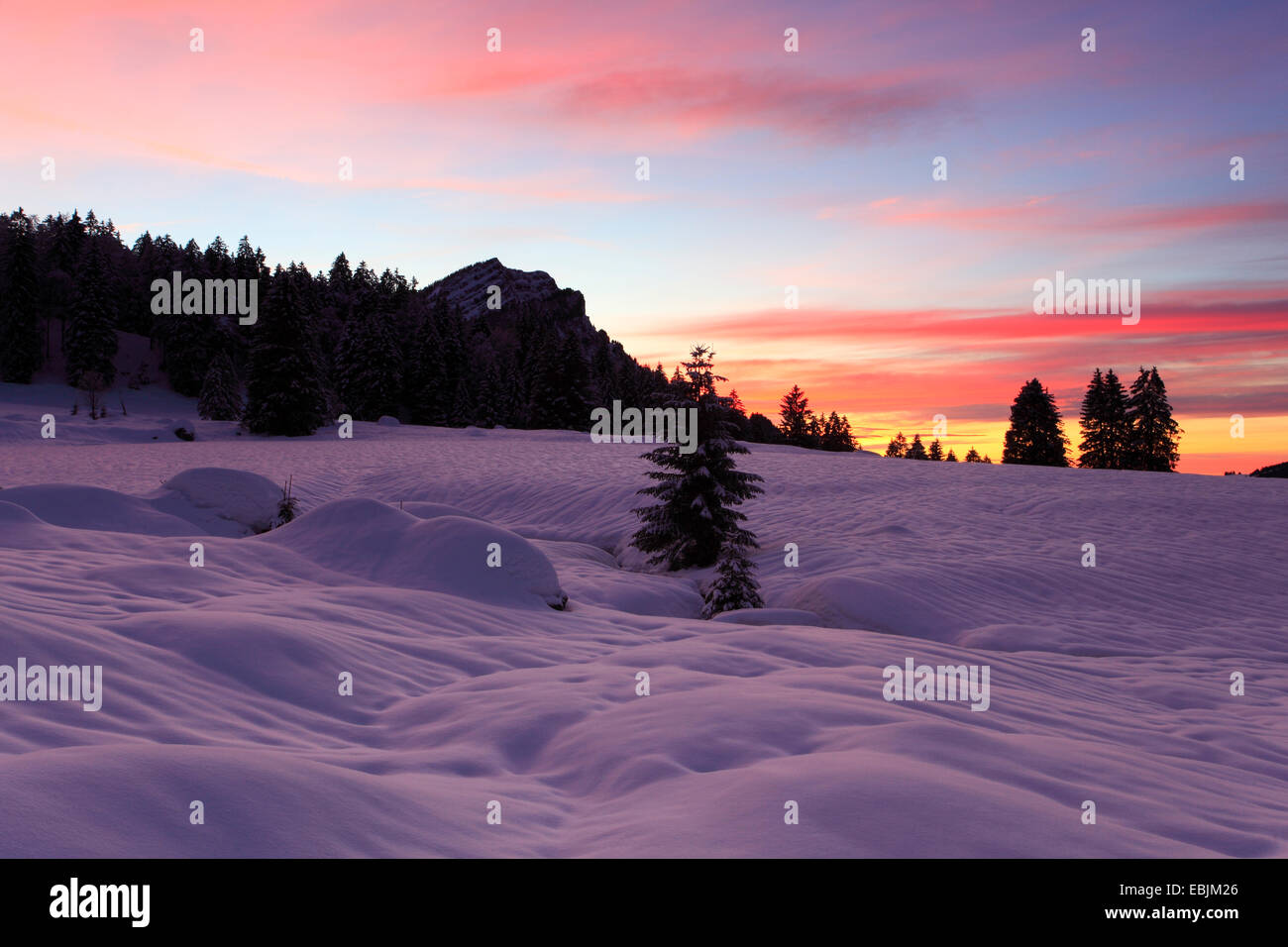 red sky over snow-covered plain in the Appenzell Alps, Switzerland ...
