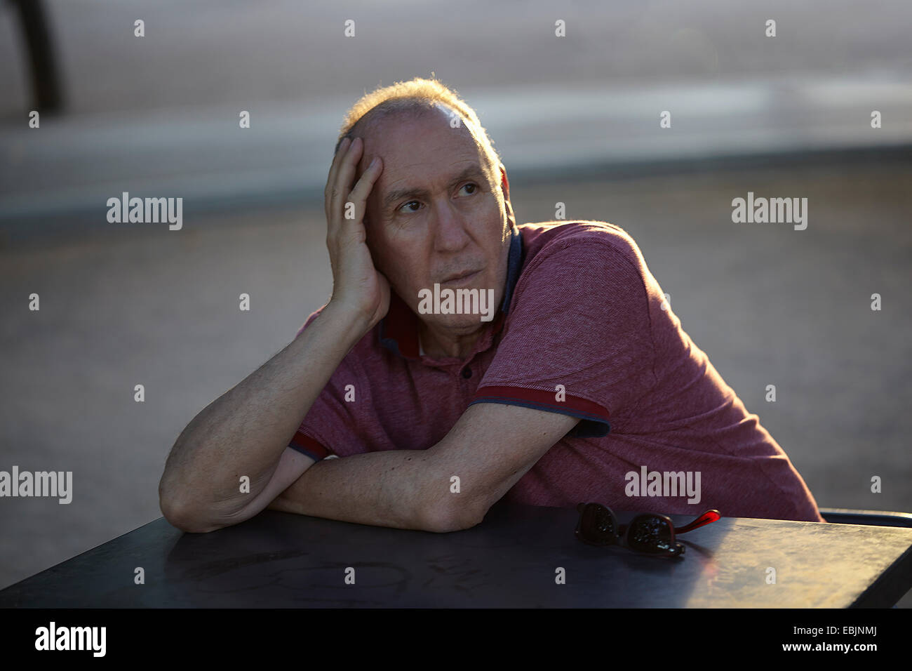 Old man sitting at table hi-res stock photography and images - Alamy