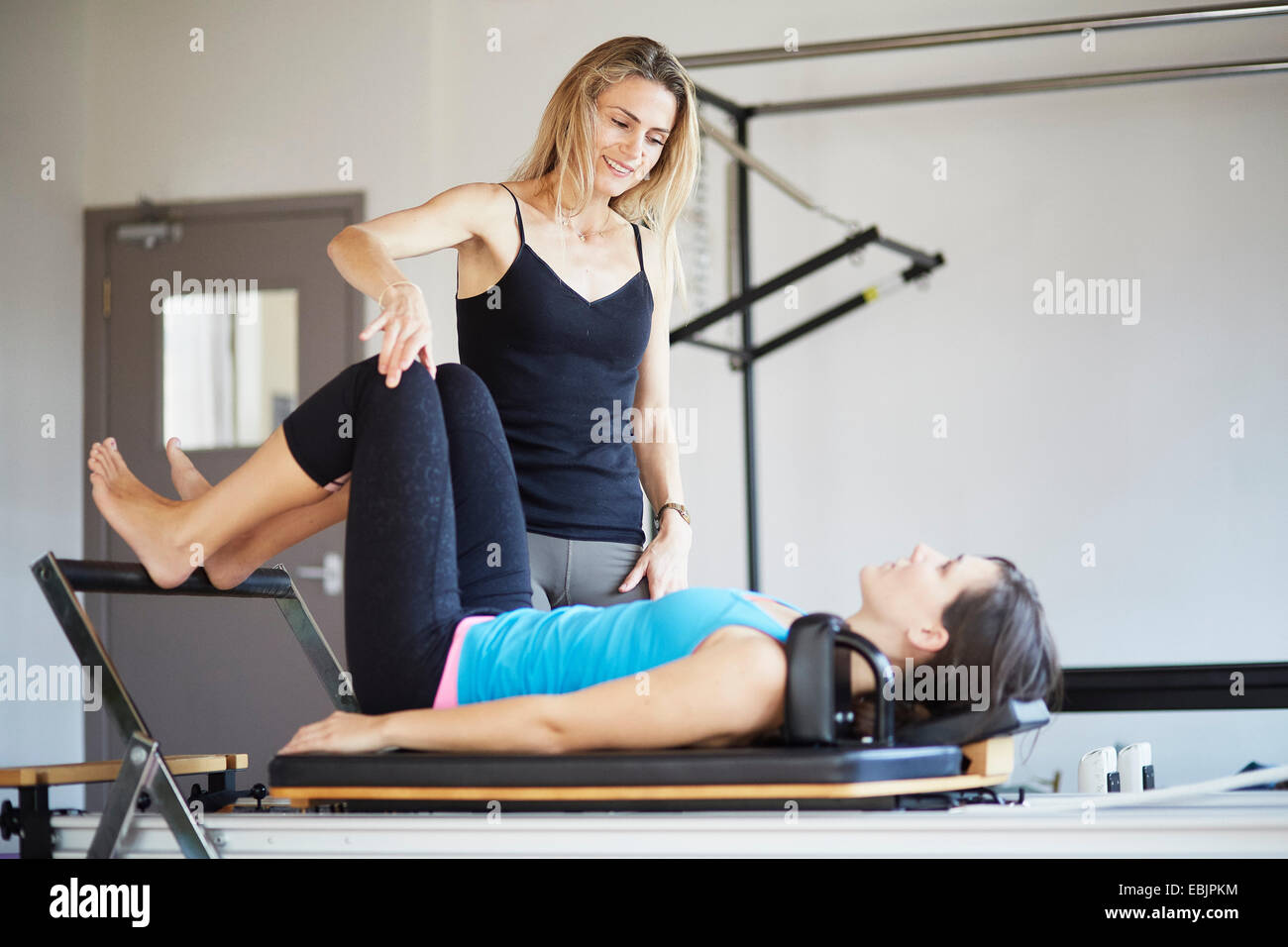 Woman lying on reformer hi-res stock photography and images - Alamy