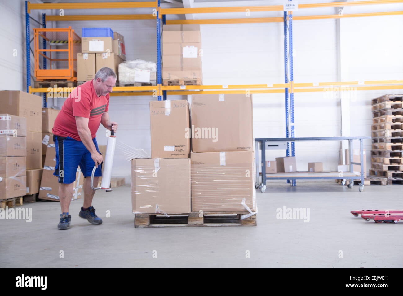 Worker packing at healthcare warehouse Stock Photo - Alamy