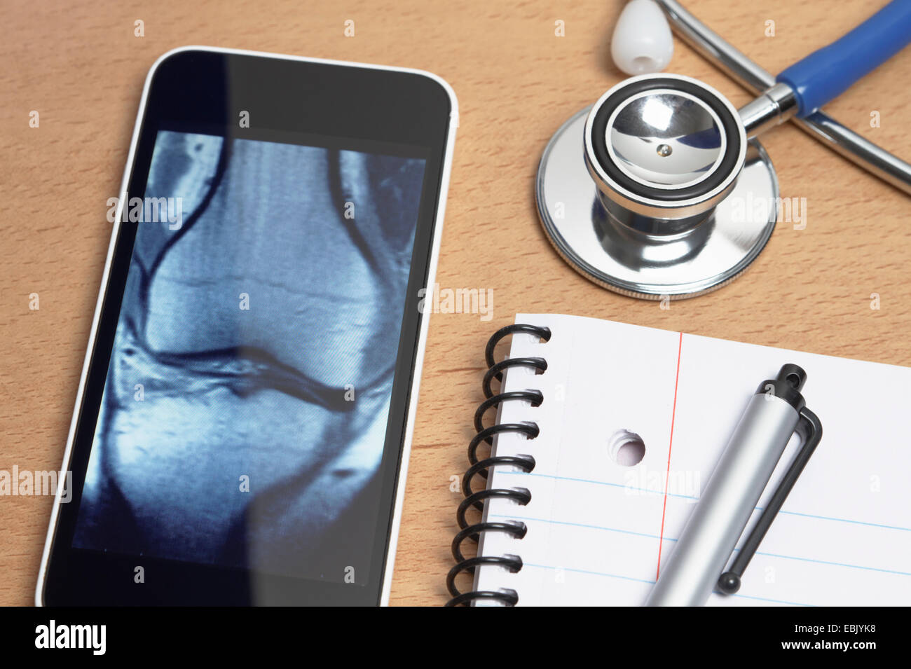 Technology use in healthcare. Smartphone displays an X-ray CT scan of a ...