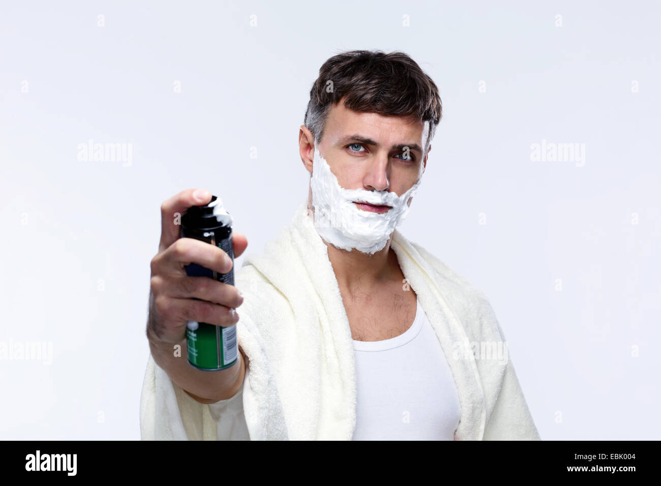 Man with shaving cream over gray background Stock Photo - Alamy