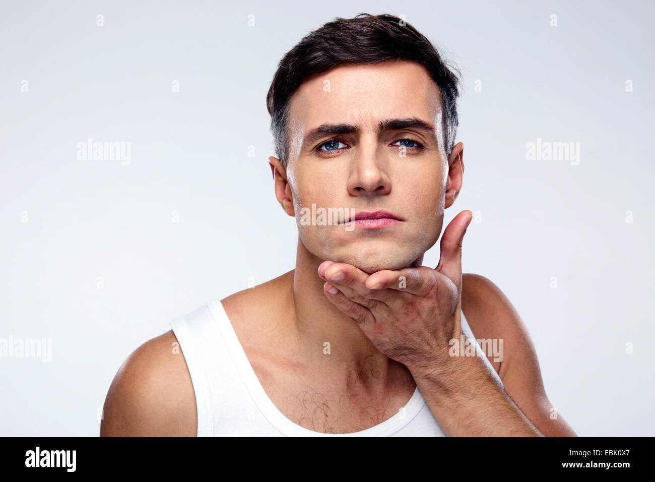 Young man after shaving over gray background Stock Photo - Alamy
